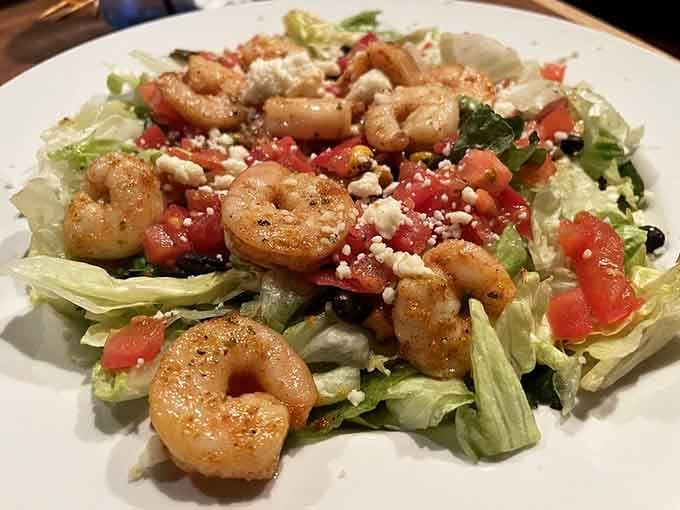 Plump shrimp nestled on fresh greens with crumbled cheese&mdash;a lighter option that doesn't skimp on satisfaction.