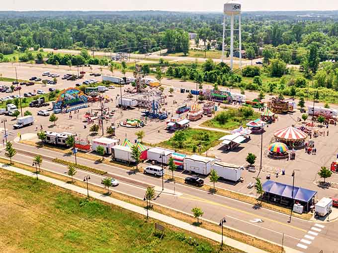 Summer festivals sprawl across fairgrounds where cotton candy costs less than your monthly parking used to elsewhere.