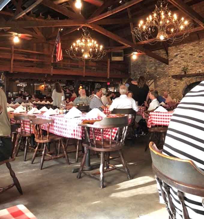 Those red checkered tablecloths and warm lighting create an atmosphere where strangers become friends over exceptional food.