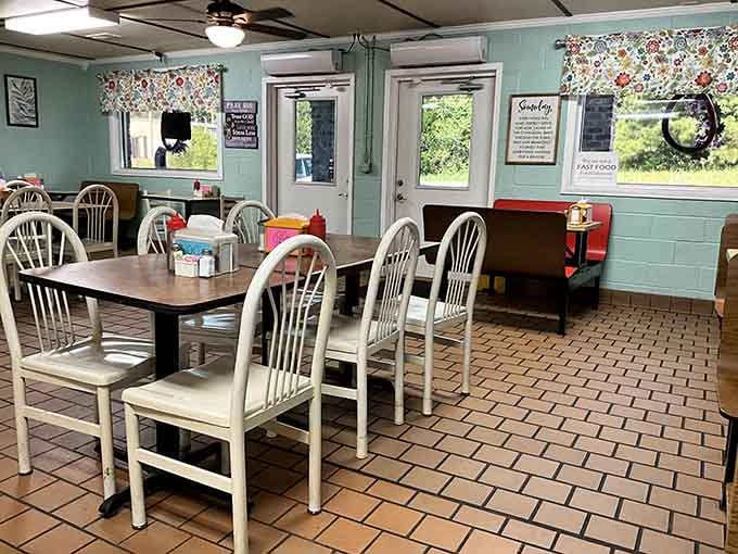 Floral curtains and aqua walls create the kind of cozy atmosphere where conversations flow as freely as the coffee.