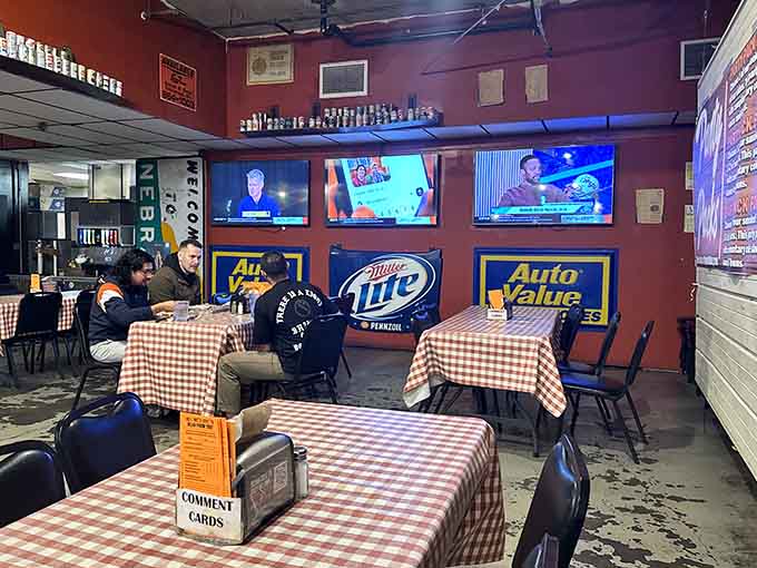 Multiple TVs and checkered tablecloths create the perfect backdrop for enjoying smoked meat with friends and strangers alike.