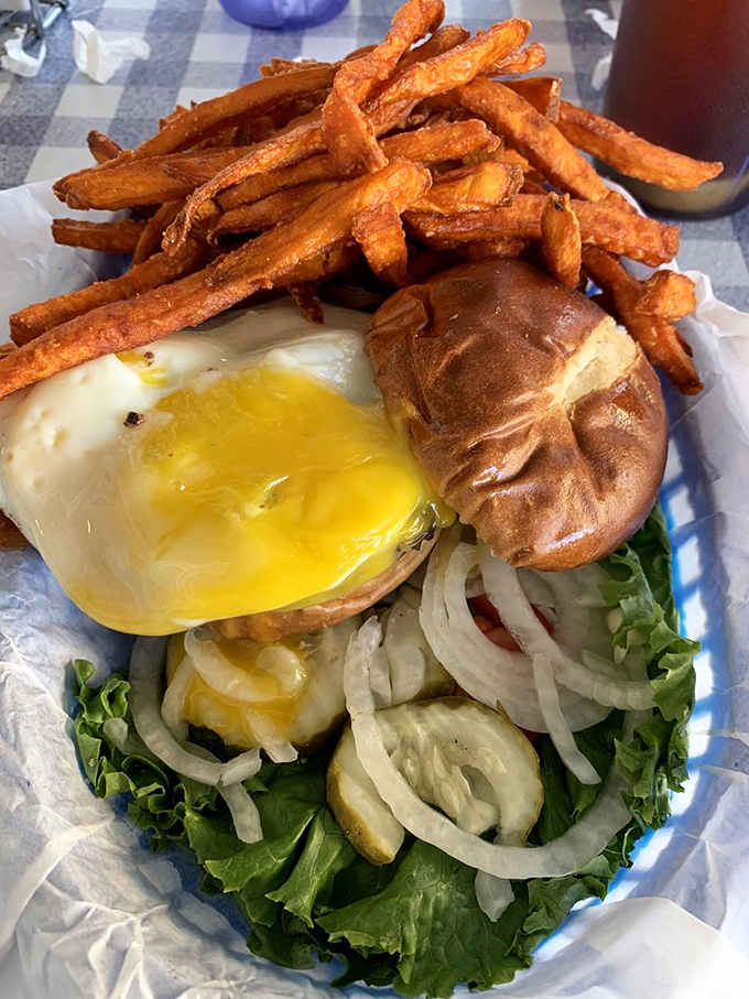 That burger's sitting on a bed of lettuce like it's posing for its yearbook photo, golden and glorious.