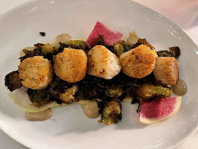 Scallops seared to caramelized perfection over Brussels sprouts is the kind of pairing that makes you believe in culinary destiny.