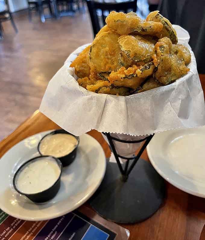 Fried pickles stacked in a cone with dipping sauces are proof that some inventions deserve awards and applause.