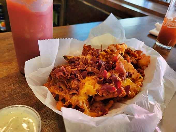 Waffle fries piled high with cheese and bacon, because sometimes you need carbs that come with their own party.