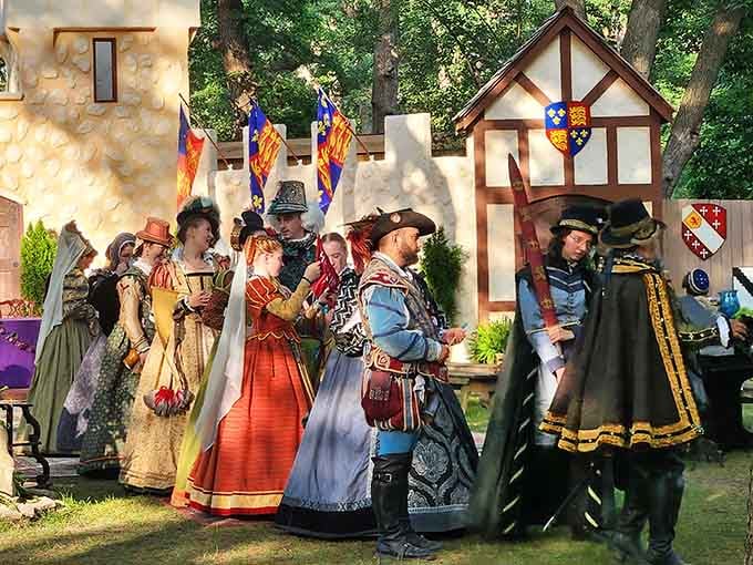Elaborately costumed nobles gather near the castle walls, their outfits representing months of dedicated historical research and sewing.