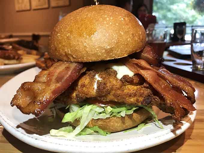 The Chickenator sandwich stacked so high it requires an engineering degree to eat it properly.