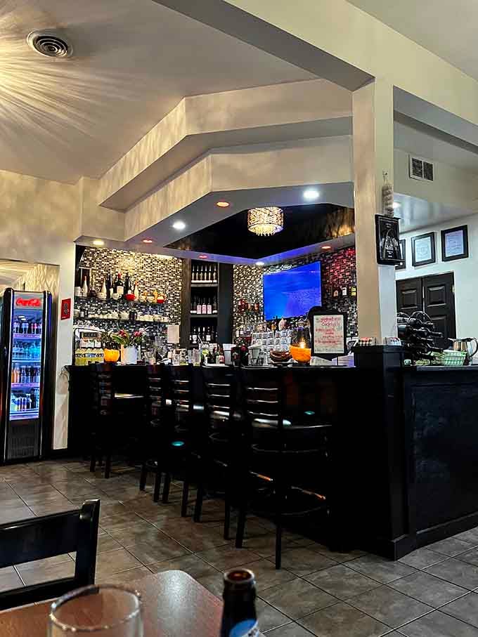 The sparkling bar beckons with bottles lined up like soldiers ready to serve, while crystal fixtures add just enough glamour.