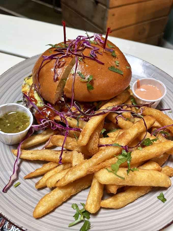 Even the burger gets the tropical treatment here, towering high with toppings and served alongside perfectly golden fries.