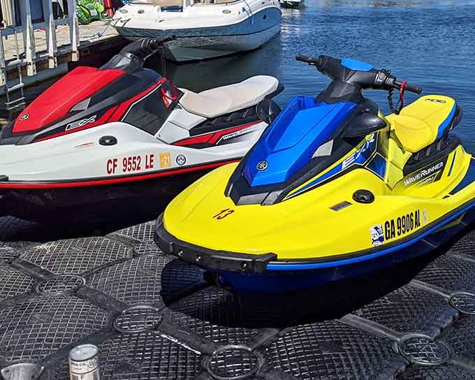 Colorful jet skis lined up like candy, ready to turn the bay into your personal playground.