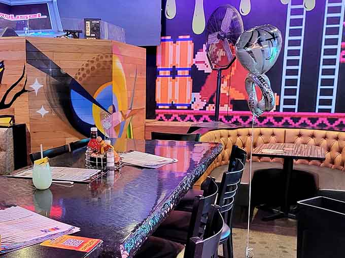 Tufted booths meet pixel art in a mashup that somehow works better than pineapple on pizza ever could.