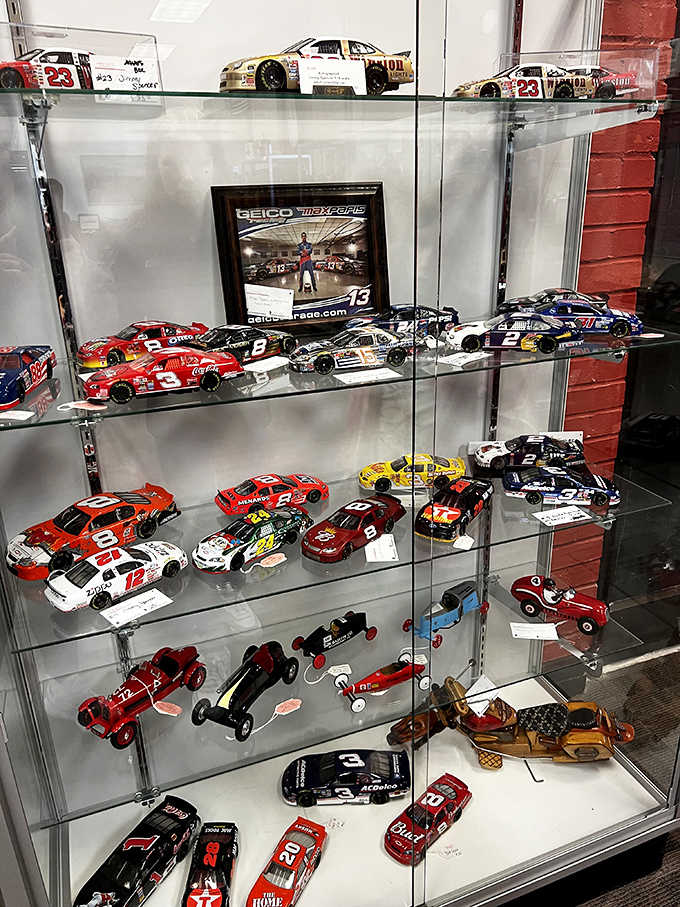 Diecast NASCAR collectibles fill the case, capturing racing history one miniature vehicle at a time for devoted fans.