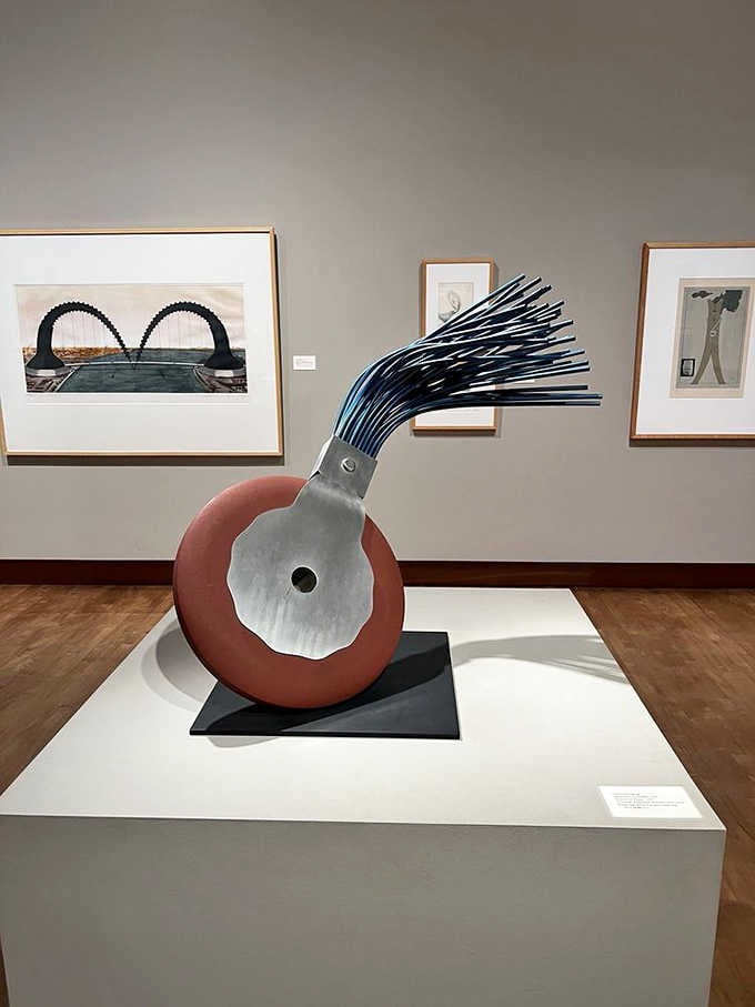 Metal and terra cotta unite in playful harmony, creating a whimsical sculpture that defies conventional artistic boundaries.