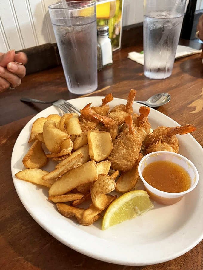 Golden coconut shrimp and crispy chips create a plate that looks like edible sunshine arrived.