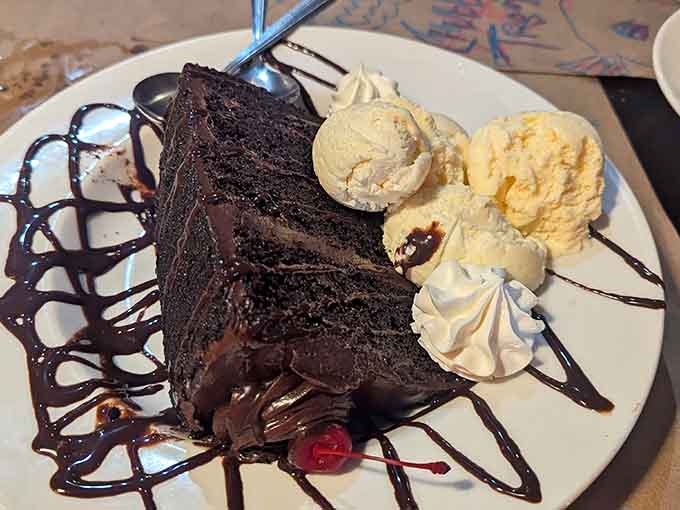This towering chocolate cake slice with ice cream is basically dessert's way of saying "diet starts tomorrow, friend, and we both know it."