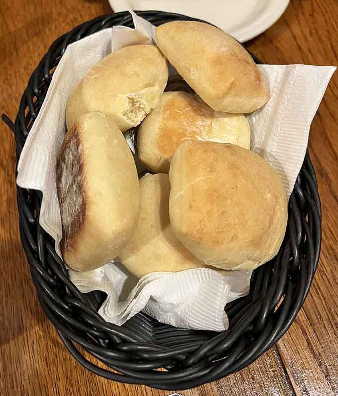 Fresh bread rolls in a basket might seem simple, but they're the warm hug that starts every great meal right.