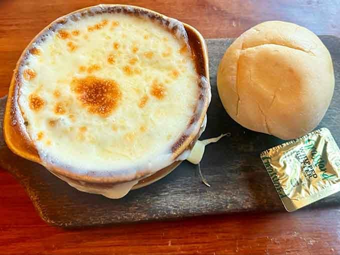 French onion soup with that perfectly melted cheese blanket that makes you want to write poetry about comfort food.