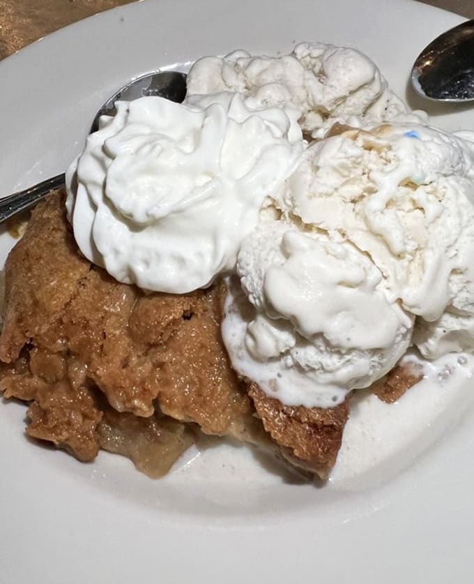 Apple cobbler crowned with vanilla ice cream&mdash;the kind of dessert that makes you understand why people invented stretchy pants.