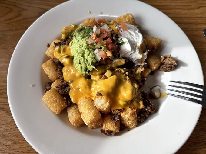 Tater tots meet nacho toppings in this glorious mashup that would make any college student weep with joy.