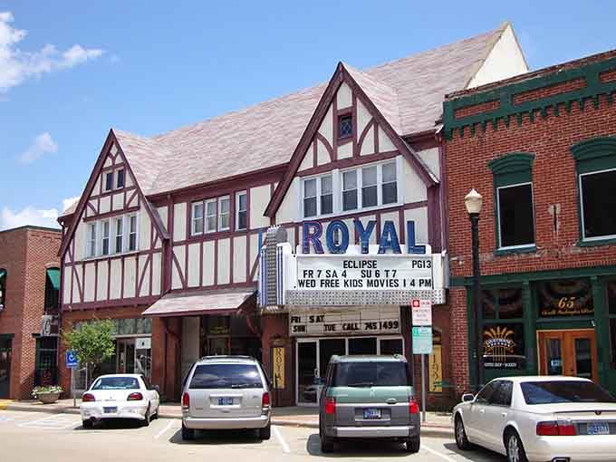 Tudor-style architecture frames the Royal Theater's marquee, where community entertainment thrives like it's still the golden age of cinema.