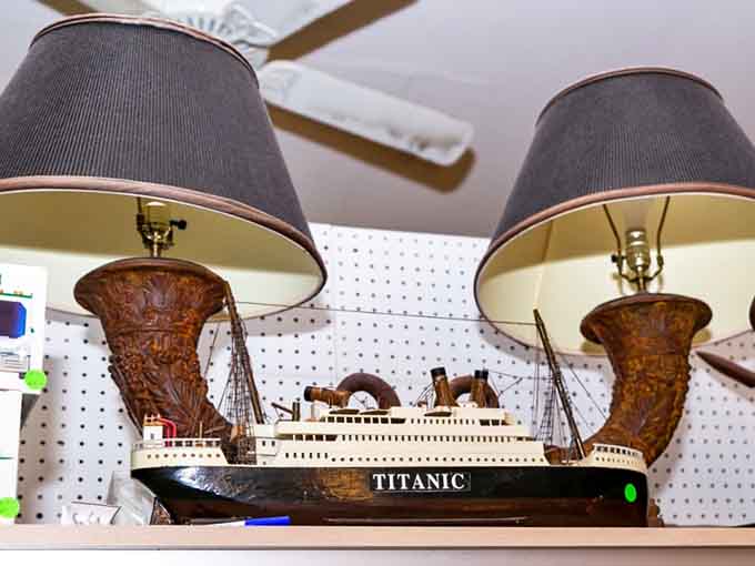 Twin lamps flank a Titanic model, creating an oddly poetic tableau about journeys through time and across oceans.