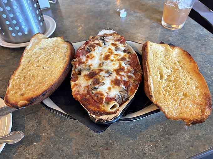Baked pasta with those golden garlic bread soldiers standing guard over bubbling cheese and sauce perfection.