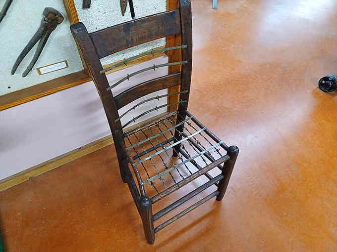 Even the furniture gets the barbed wire treatment here, though you probably shouldn't sit on this particular wooden chair.