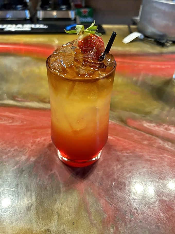 A tropical cocktail garnished with fresh fruit, colorful enough to make even a T-Rex pause and appreciate the bartender's artistry.