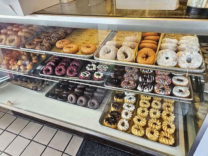 The donut case at Donut Drive In: where decision-making becomes delightfully difficult and wonderfully overwhelming every single time.