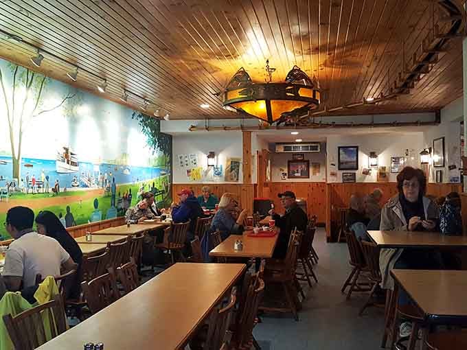 Wooden chairs, warm lighting, and that mural create the kind of cozy atmosphere where calories magically don't count.