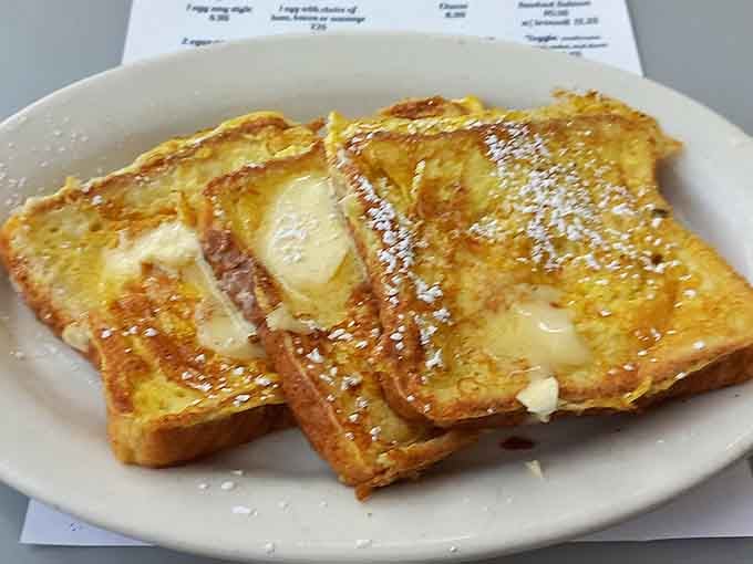 French toast dusted with powdered sugar, golden and inviting like a warm hug on a plate.