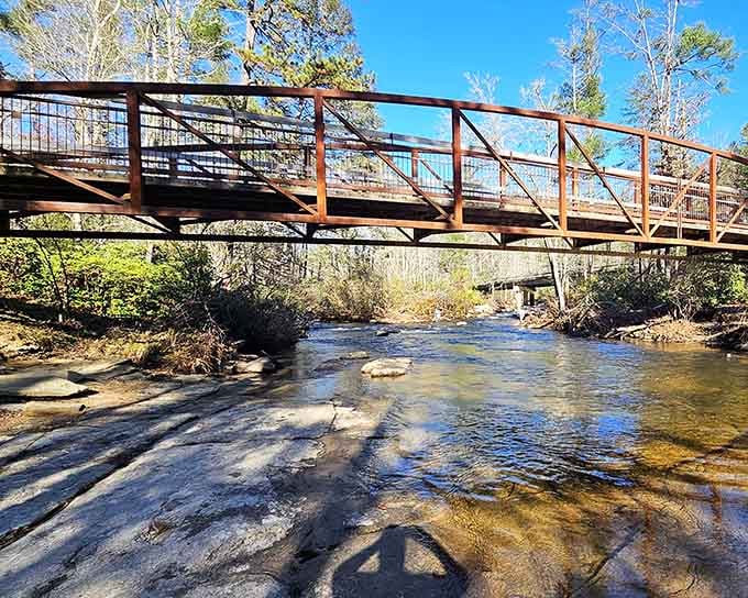 Crystal-clear mountain water flows beneath this sturdy bridge, connecting you to wilderness without getting your feet soaked.