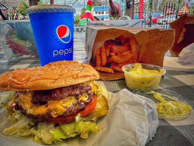 Double patties stacked high with cheese cascading down like a dairy waterfall, pickles providing the perfect tangy counterpoint.