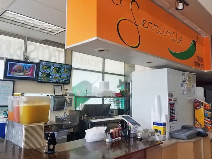 The bright orange El Serranito sign and open kitchen setup let you watch your meal come together in real time.