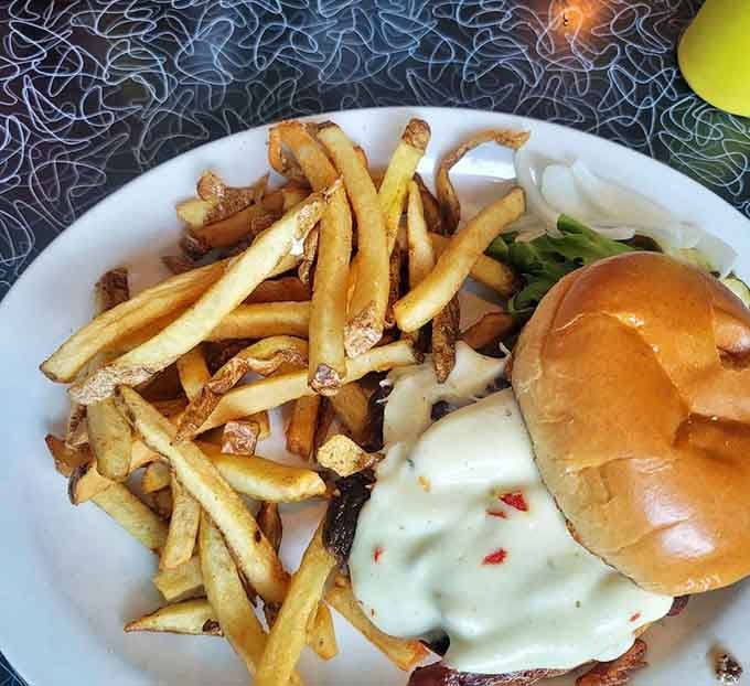 This burger and fries combo requires both hands, a healthy appetite, and possibly a post-meal nap strategy.