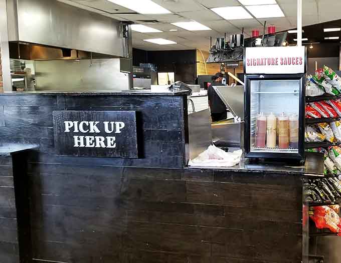 The pickup counter where culinary dreams become reality, one made-to-order meal at a time in this unexpected location.