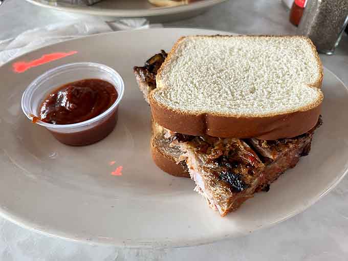 A BBQ sandwich so packed with meat, the bread is just barely holding on for dear life.
