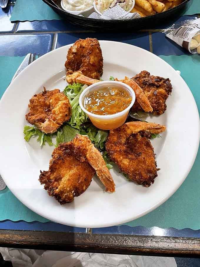 Coconut shrimp arranged like edible art, each piece a crunchy tropical vacation for your taste buds.