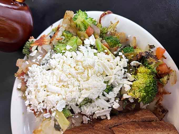 The legendary Hippie Hash combines crispy potatoes, grilled vegetables, and crumbled feta into one glorious breakfast bowl of happiness.