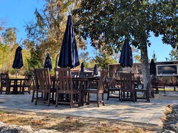 Outdoor seating with umbrellas provides shade while you contemplate the geological marvels hiding beneath your feet right now.
