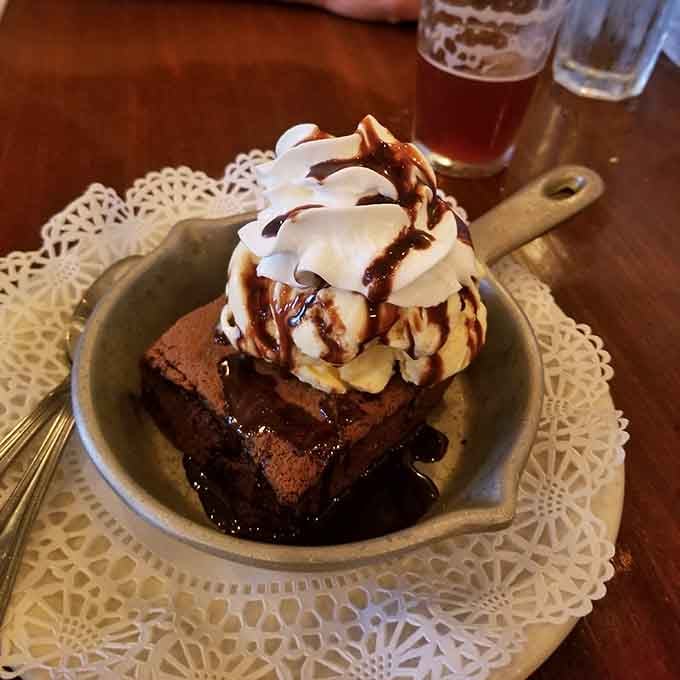 Brownie topped with ice cream and whipped cream, a dessert that doesn't apologize for its indulgence.