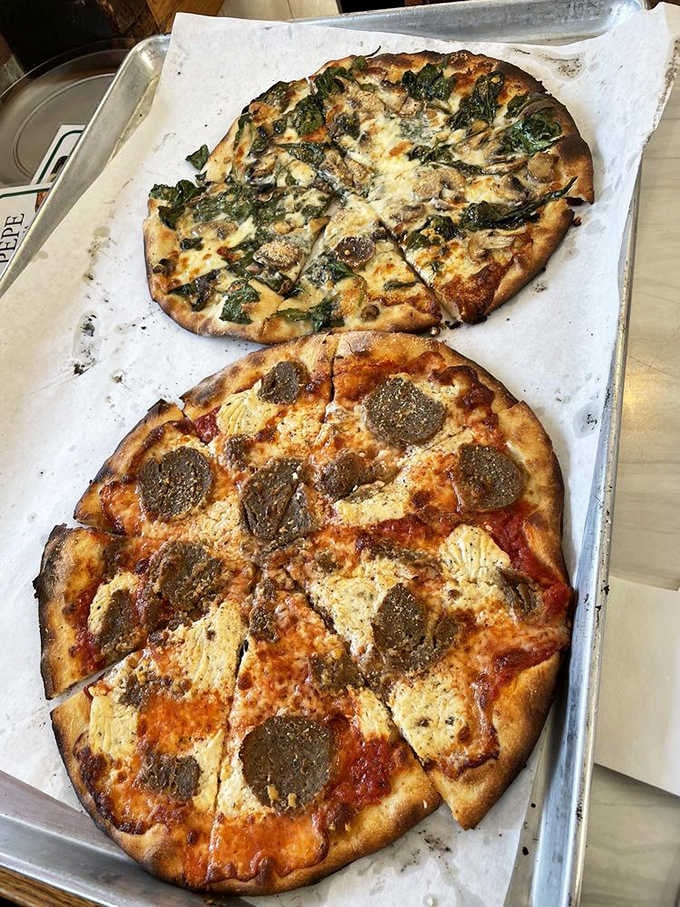 Two different pizzas showing the range of possibilities when you start with perfect dough and those magical coal-fired ovens.