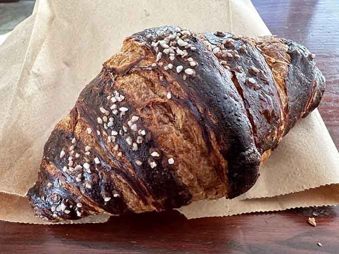 This dark, glossy Bavarian croissant with pearl sugar looks like it belongs in a Munich bakery window.