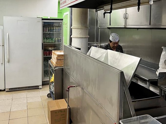 Behind that partition, dumpling magic happens faster than you can say "I'll take two orders, please."