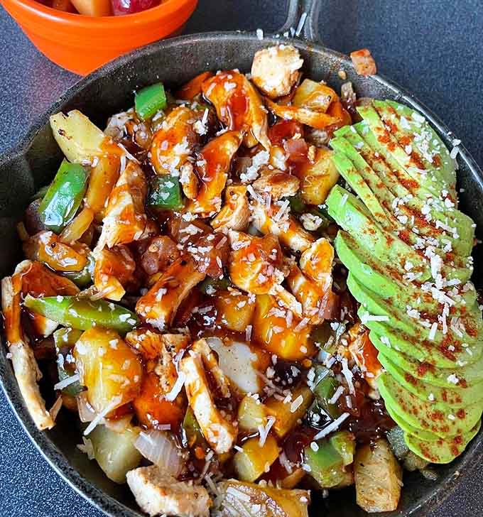 A chicken salad bowl that looks like a rainbow decided to become lunch, complete with perfectly fanned avocado slices.