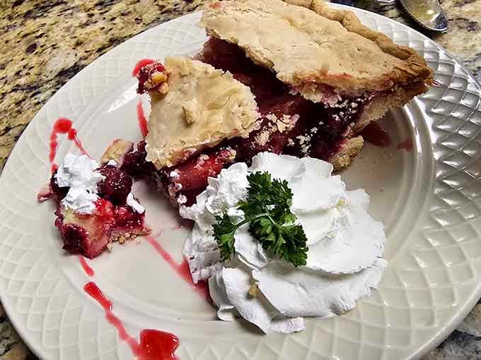 Berry pie with whipped cream rosettes fancy enough for Sunday dinner, homey enough to eat in your comfortable pants.