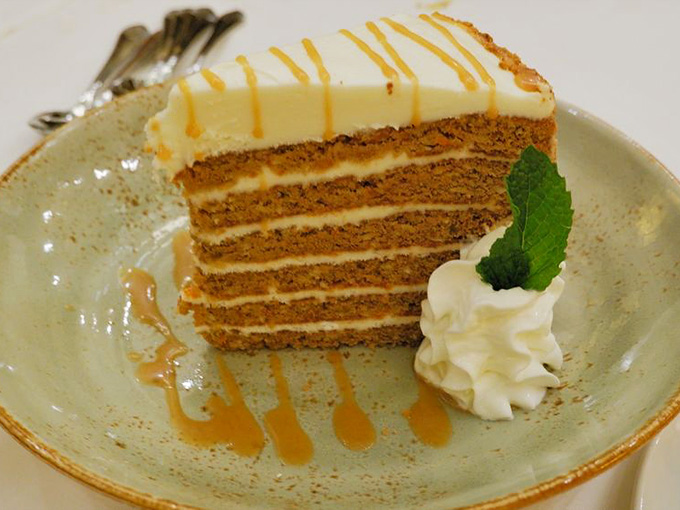Layers of carrot cake drizzled with caramel sauce whisper sweet nothings to your taste buds.