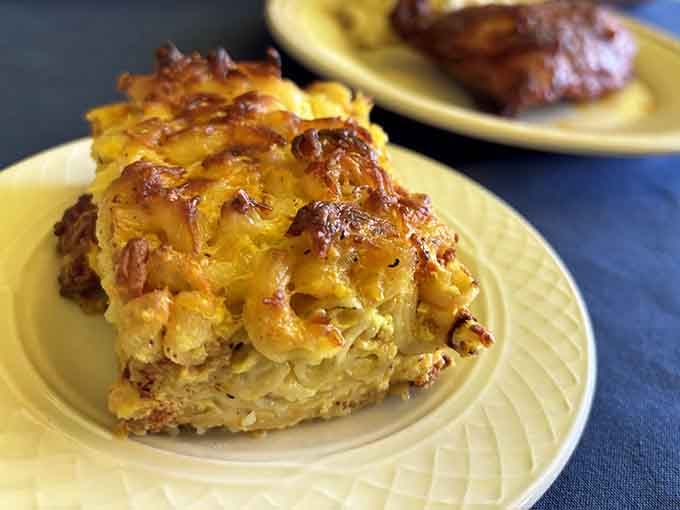 Mac and cheese with a golden-brown top that crackles when you break through, revealing creamy perfection that'll haunt your dreams forever.