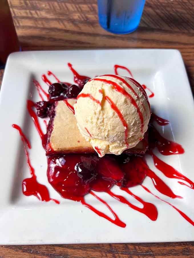 Cheesecake topped with berry compote and vanilla ice cream makes every calorie absolutely worth the guilt.