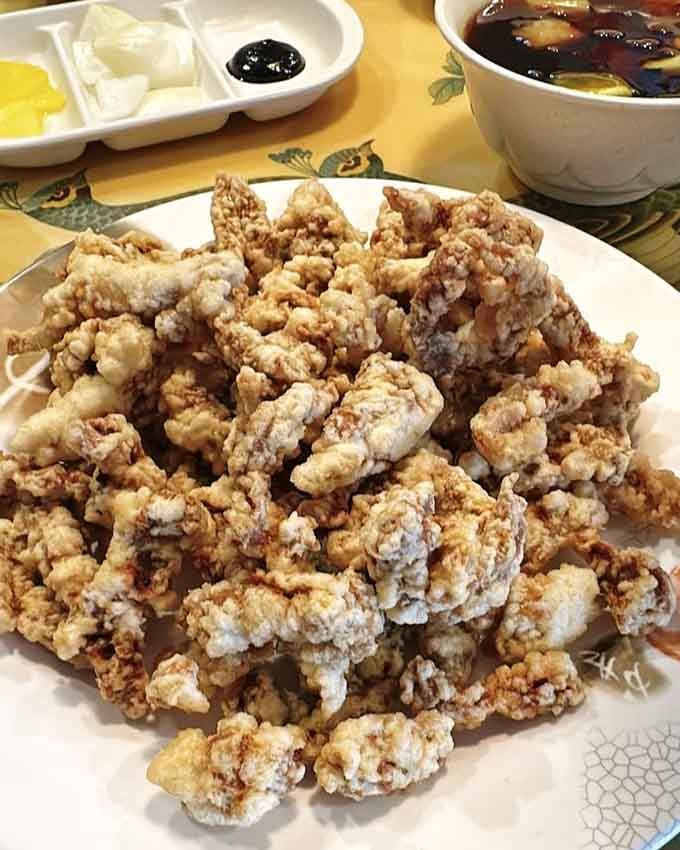 Golden, crispy pork pieces that stay crunchy even after their sweet and sour sauce bath. Pure magic.